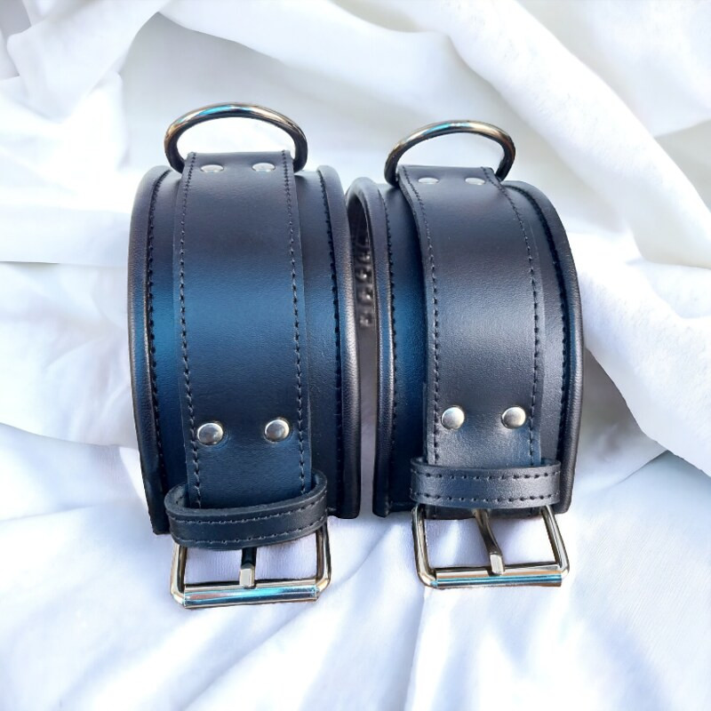 Leather BDSM ankle cuffs with spikes on the inside, adjustab